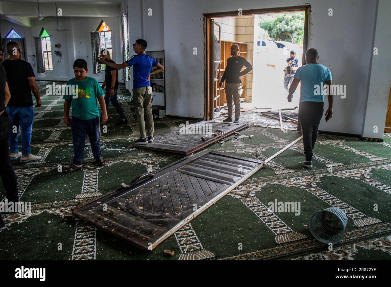 Palestinians inspect a destroyed mosque after Israeli helicopters ...