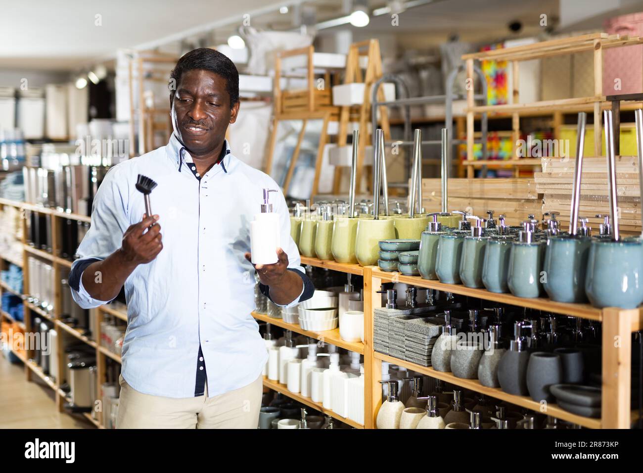 Male shopper chooses toilet brush at hardware store Stock Photo - Alamy