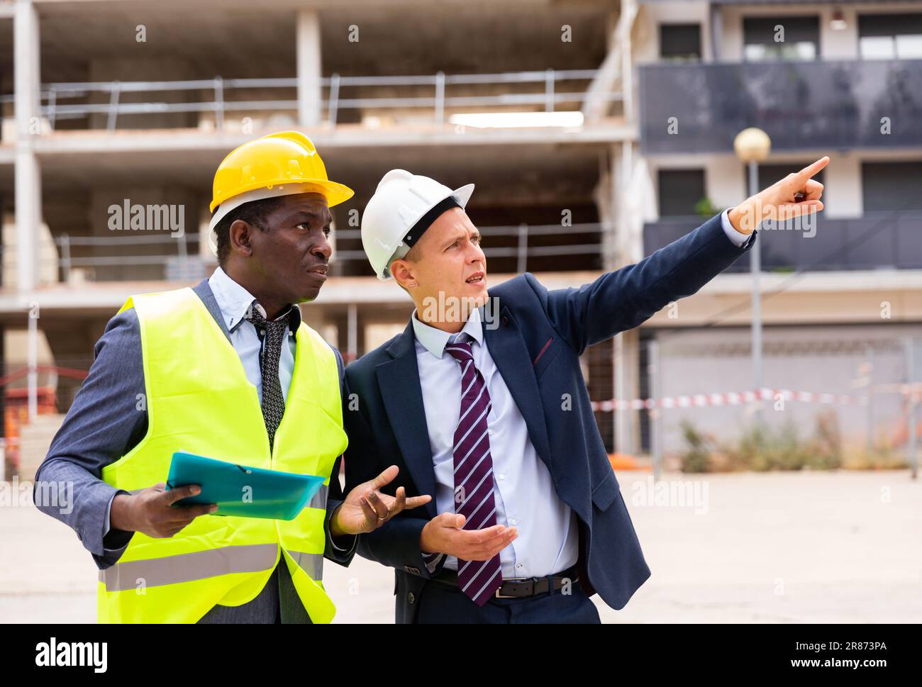 Architect and engineer talking about project of new building Stock ...