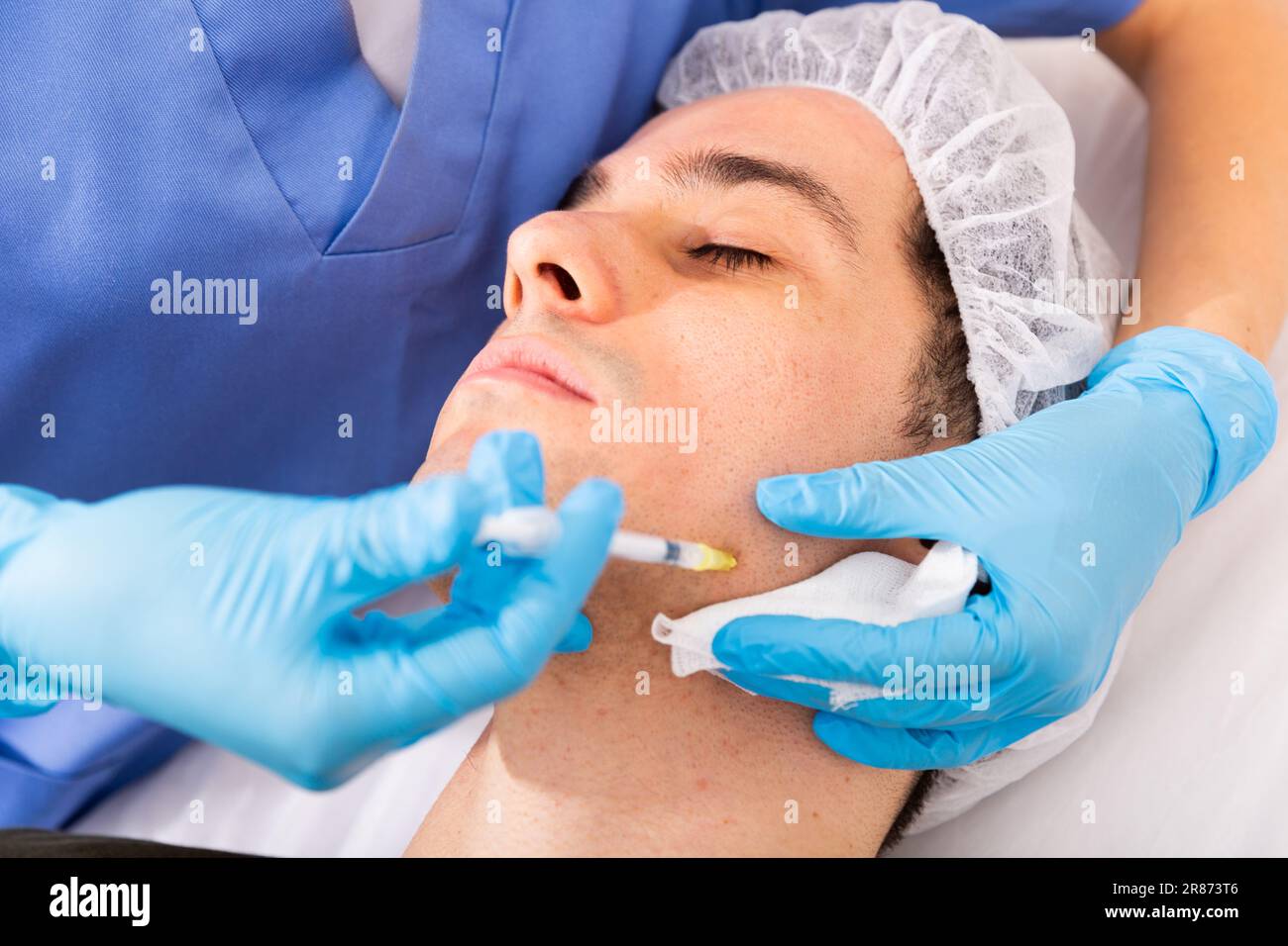 Man getting face injections at aesthetic clinic Stock Photo - Alamy