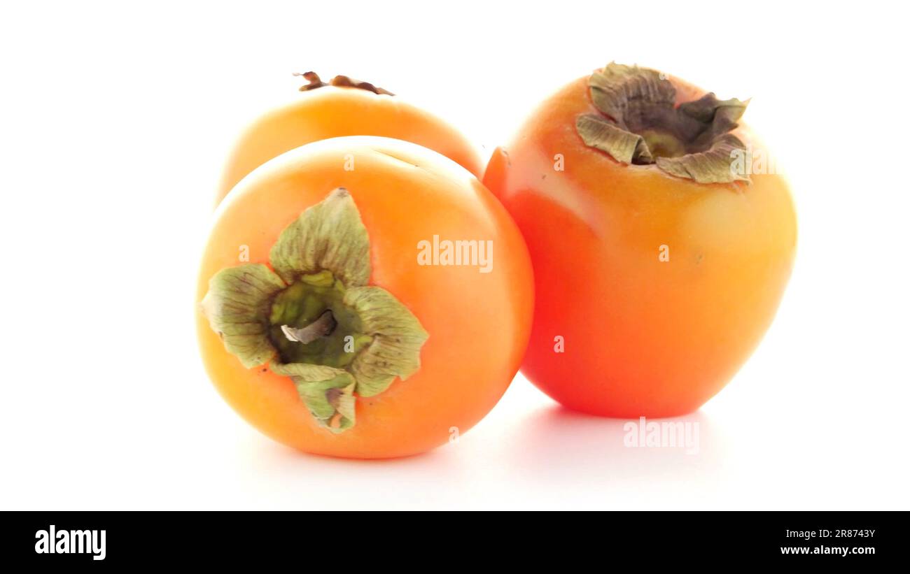 Red ripe persimmons rotating over white background Stock Photo - Alamy