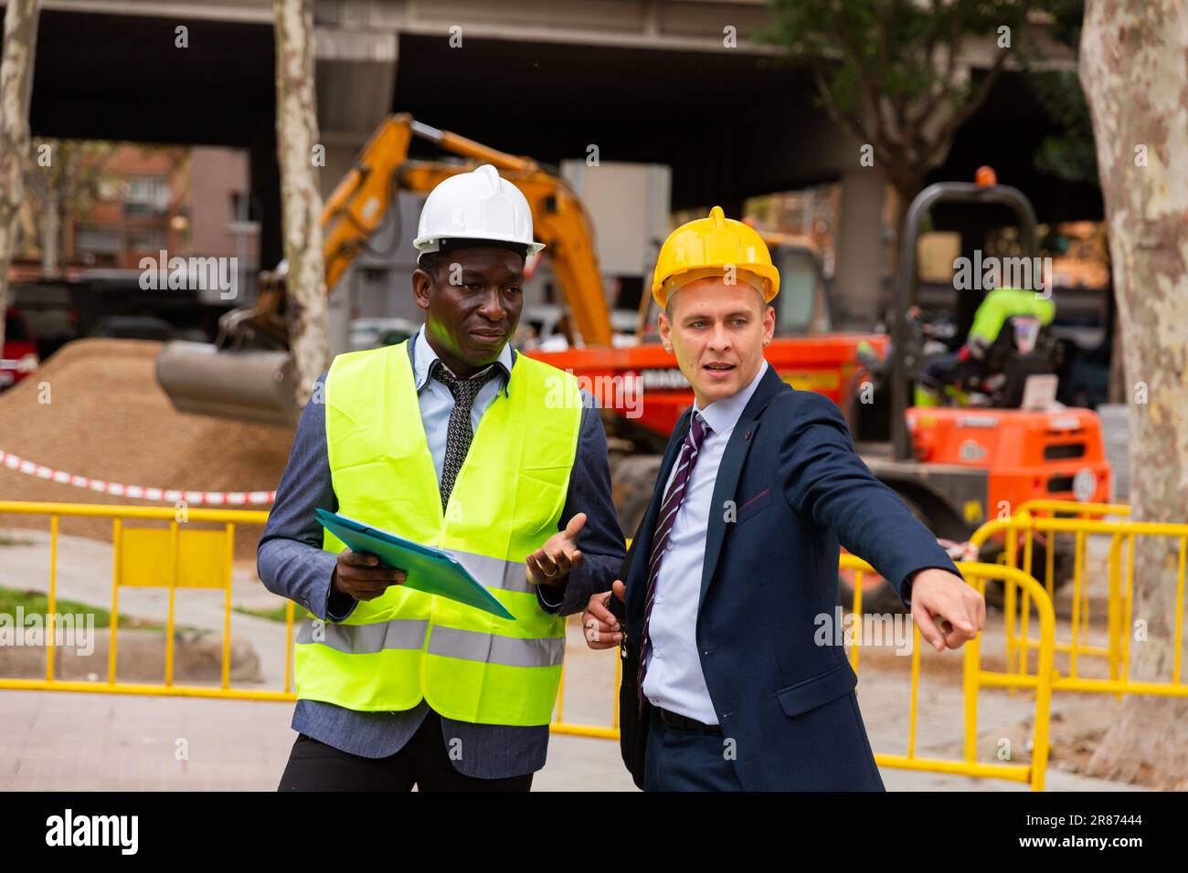 Architect tells engineer where to dig a trench to lay pipe Stock Photo ...