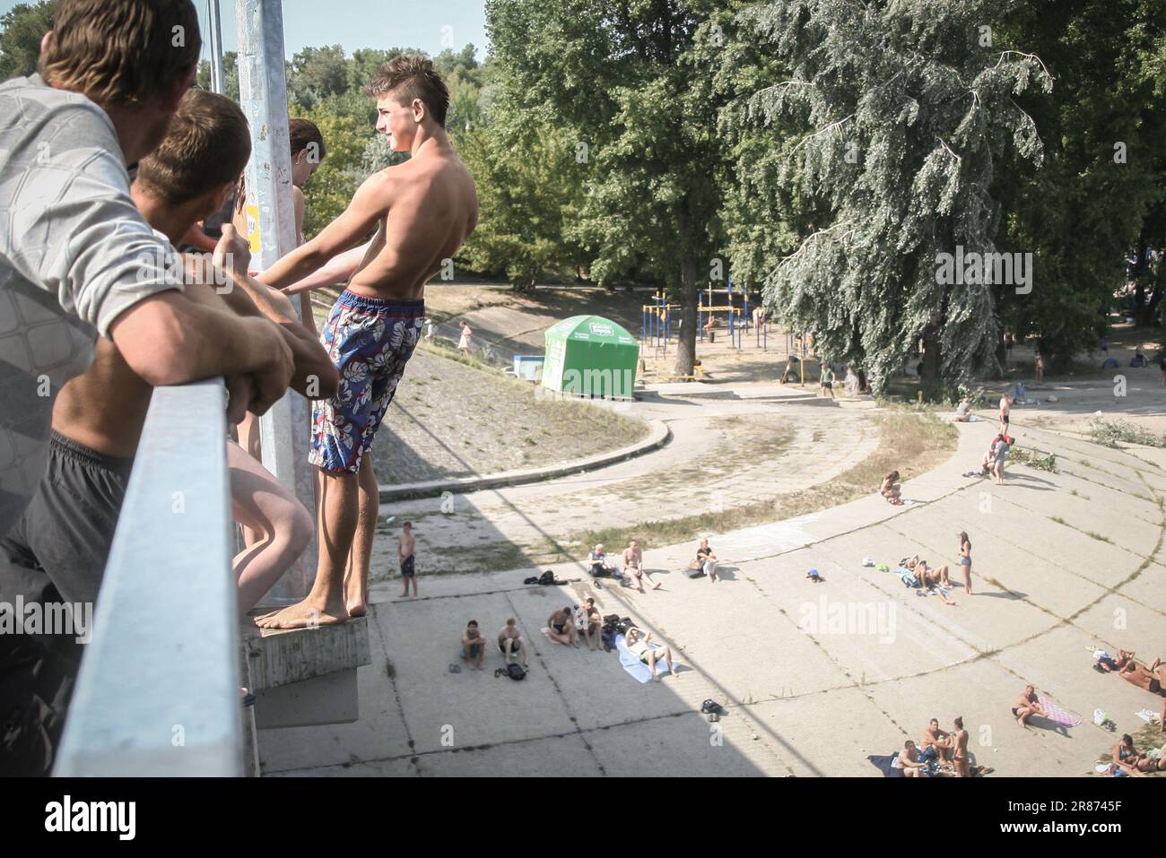 Picture of the Hidropark of Kiev, in the city center, with a Ukrainian man ready to jump and ...
