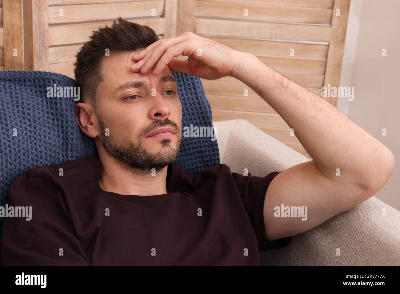 Upset man sulking on sofa at home. Loneliness concept Stock Photo - Alamy