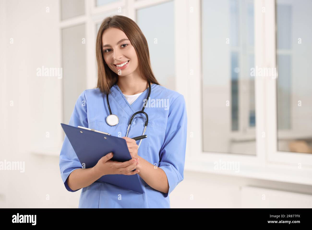 Portrait of young intern wearing uniform in university hall, space for ...