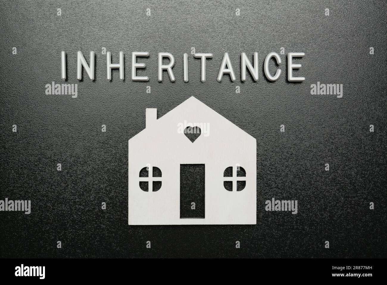 Word Inheritance made with white letters and house model on black ...