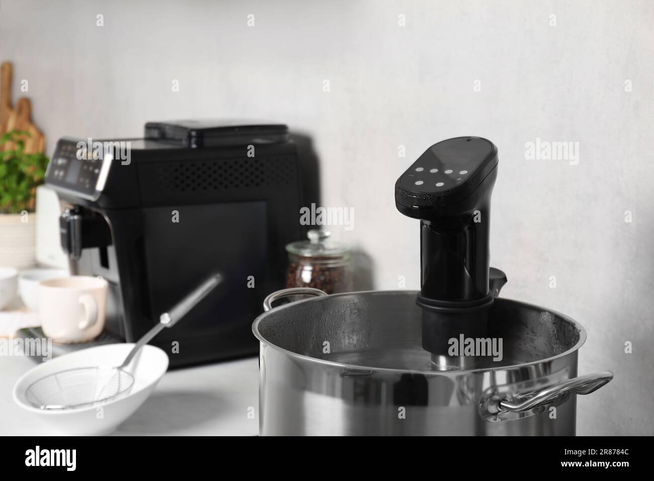 Pot with sous vide cooker in kitchen, closeup. Thermal immersion ...