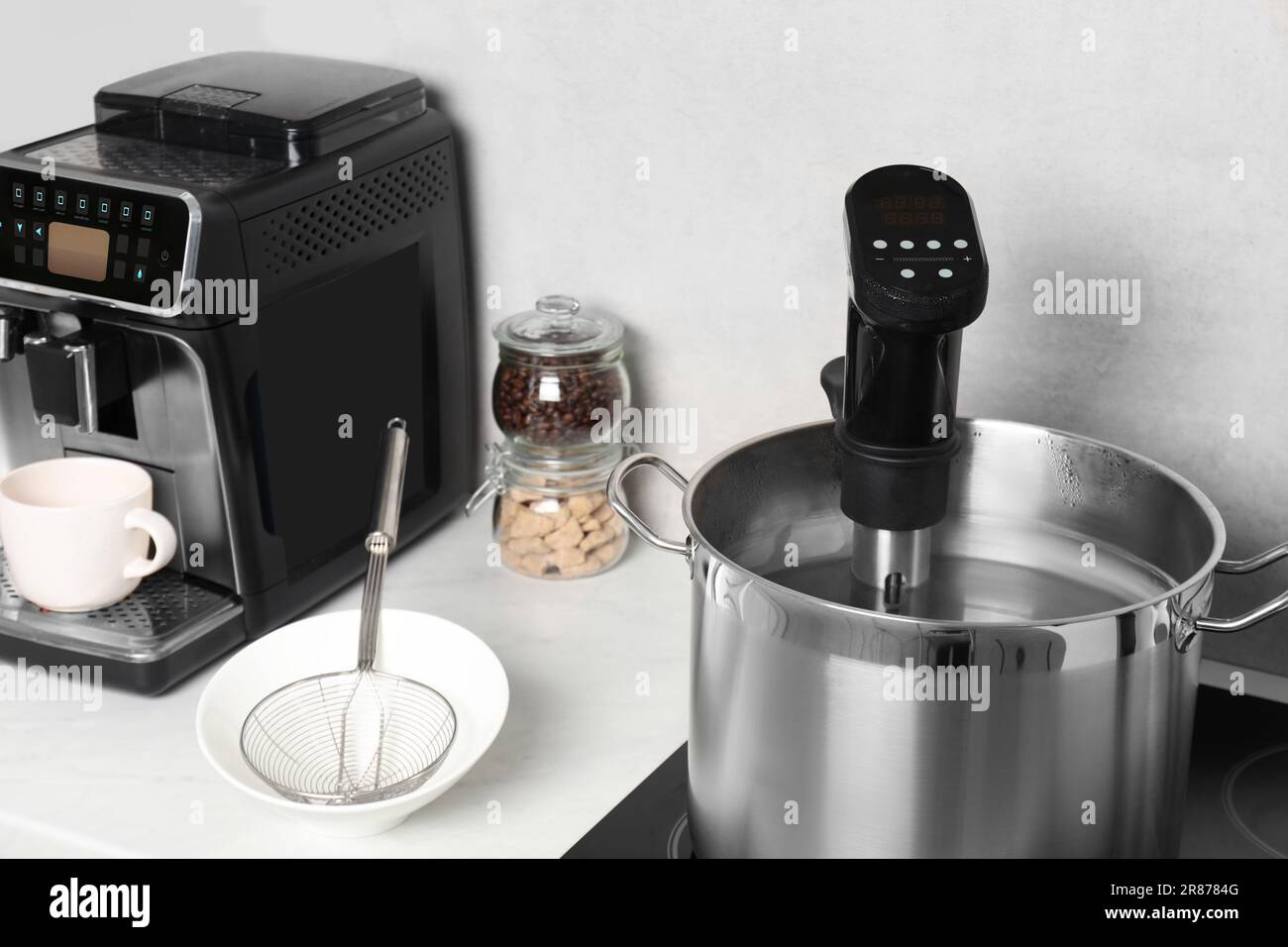 Pot with sous vide cooker in kitchen. Thermal immersion circulator ...