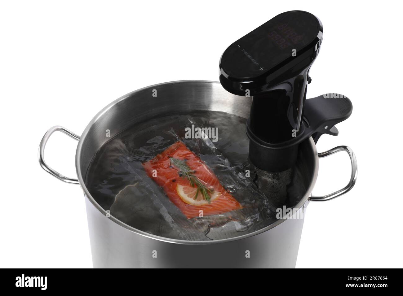 Thermal immersion circulator and vacuum packed salmon in pot on white ...