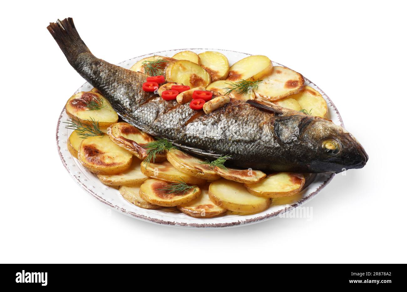 Plate with delicious roasted sea bass fish and potatoes on white ...