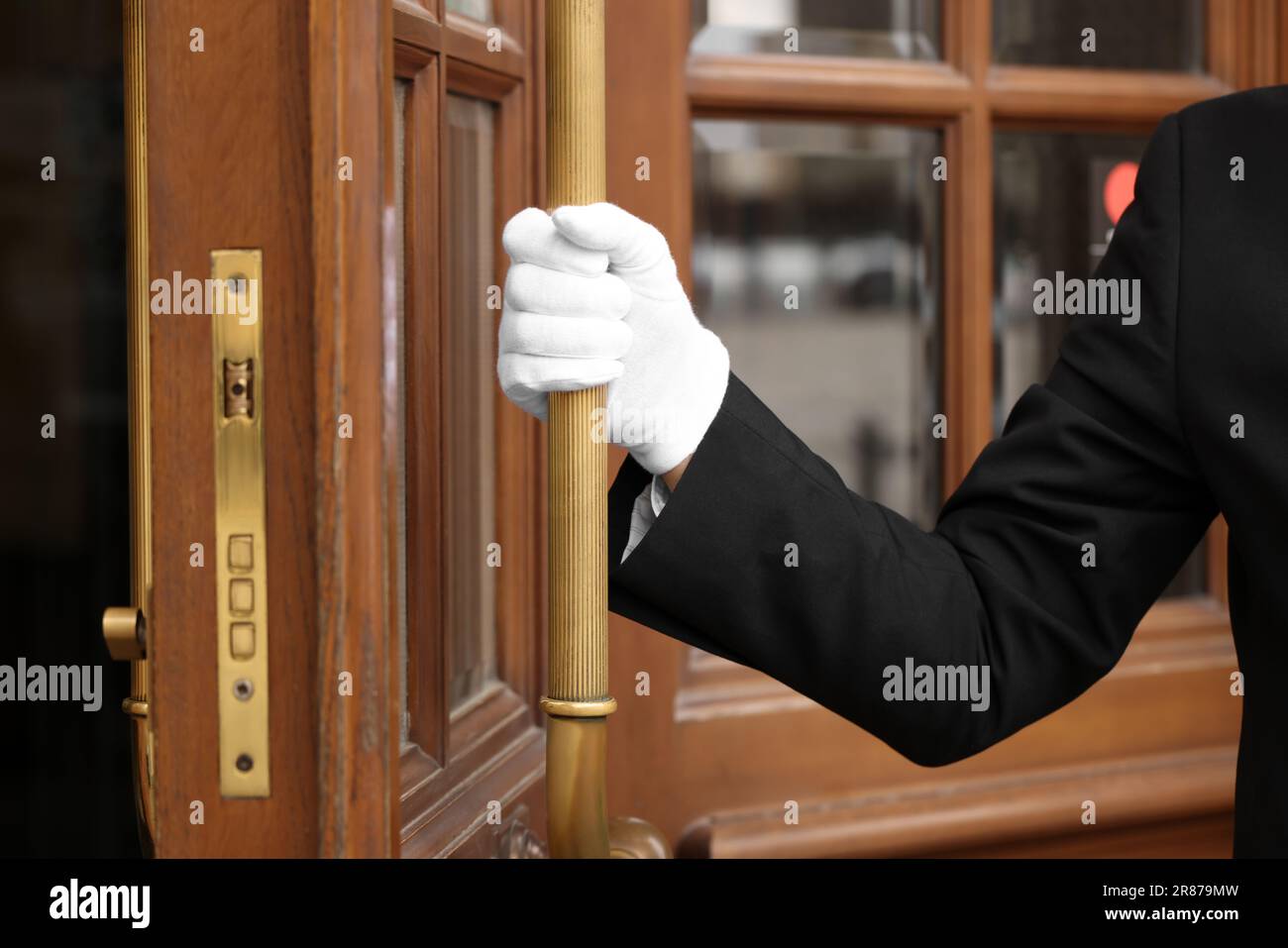 Man opening door for man courtesy hi-res stock photography and images ...