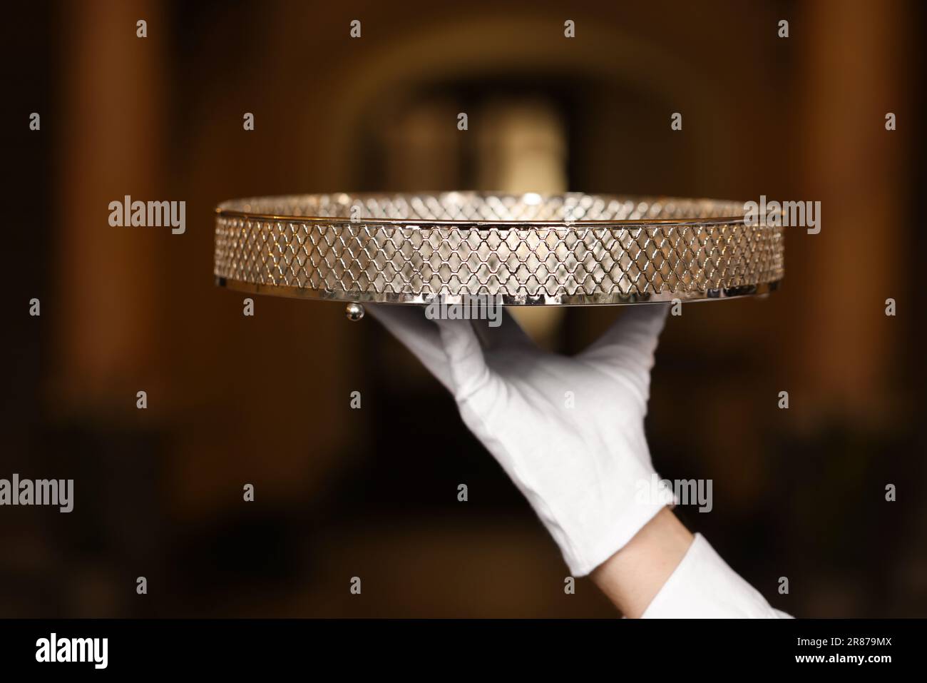Butler holding empty tray in restaurant, closeup Stock Photo - Alamy