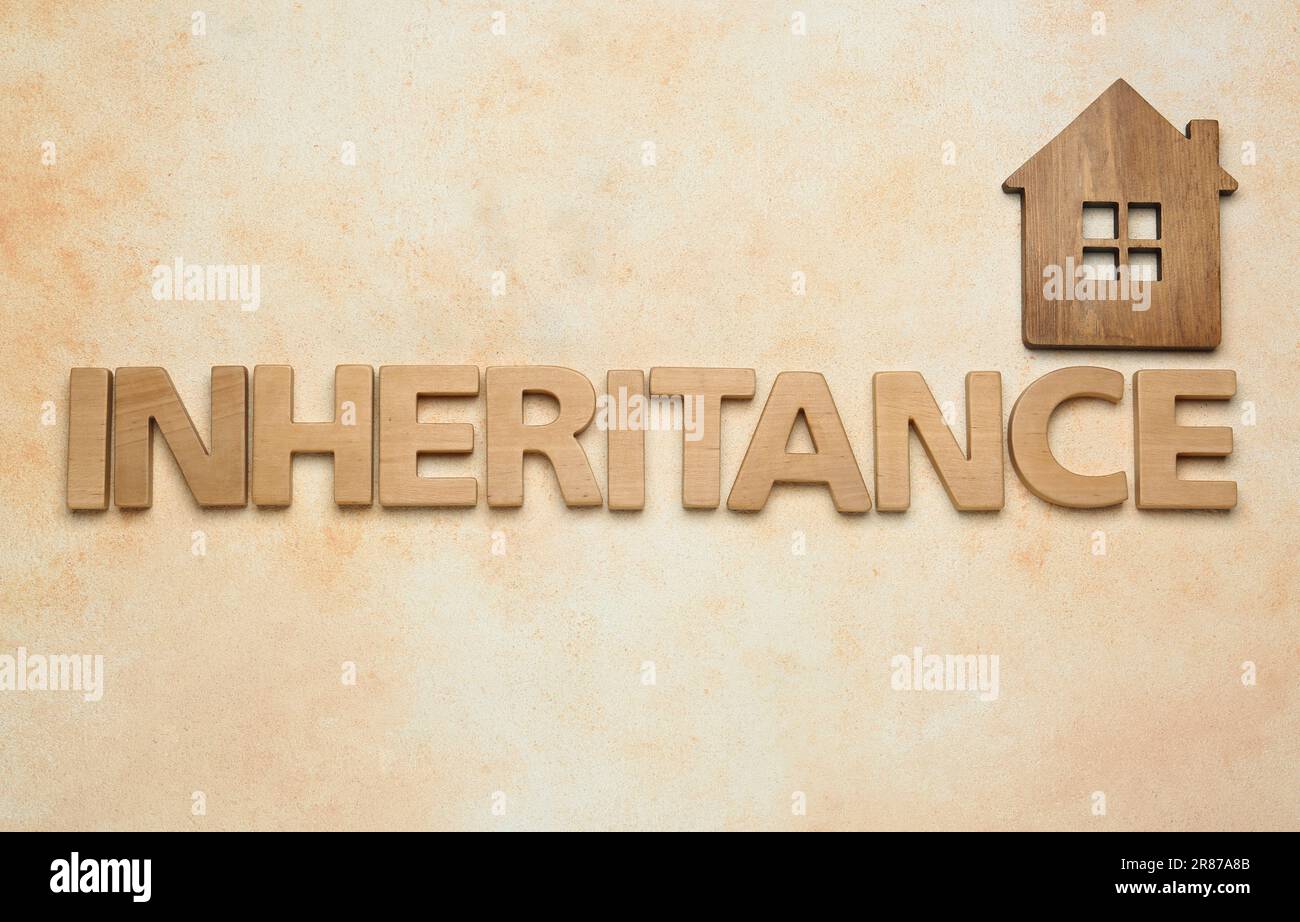 Word Inheritance made with wooden letters and house model on beige ...