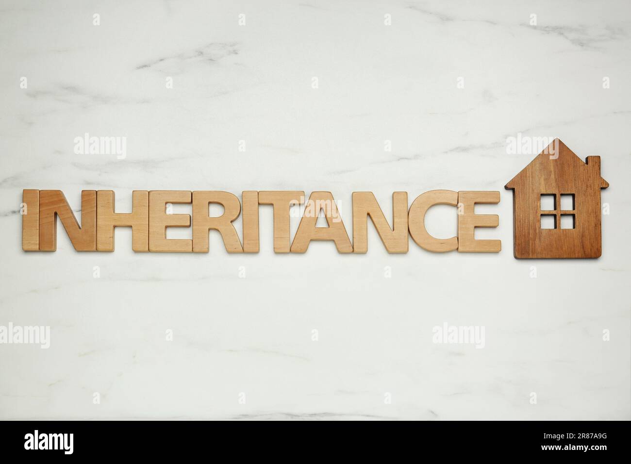 Word Inheritance made with wooden letters and house model on white ...