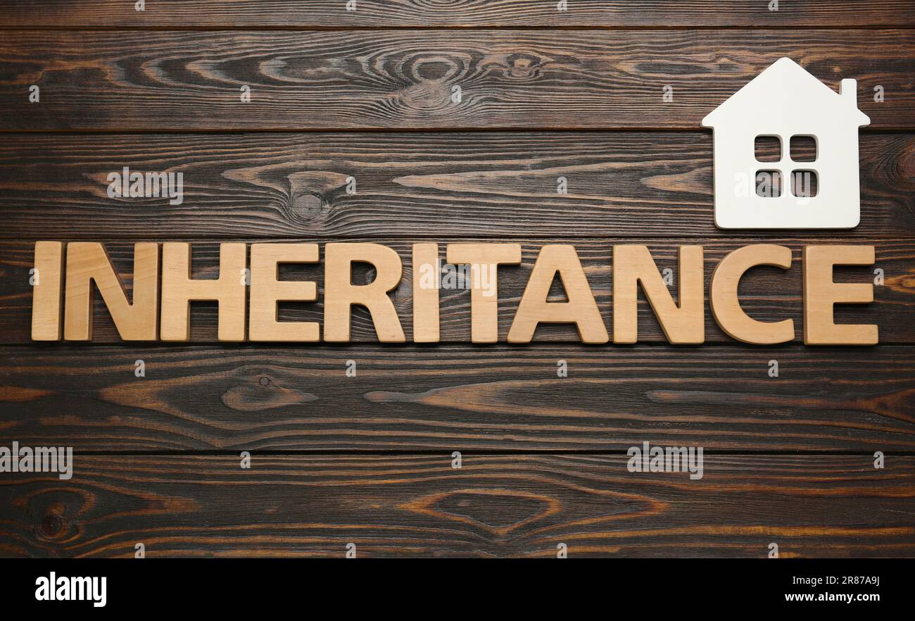 Word Inheritance made with letters and house model on wooden background ...