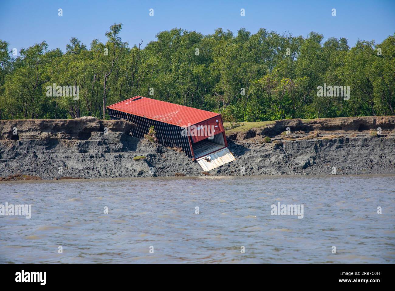 An abandoned container on the bank of a coastal mangrove forest at Dhal ...