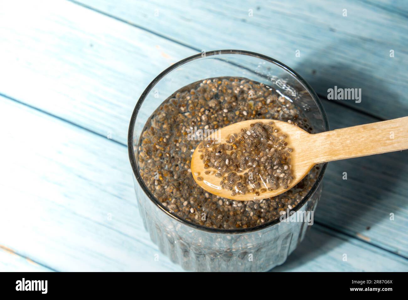 Preparing superfood water drink rich in Omega 3 fatty acids. Pouring ...