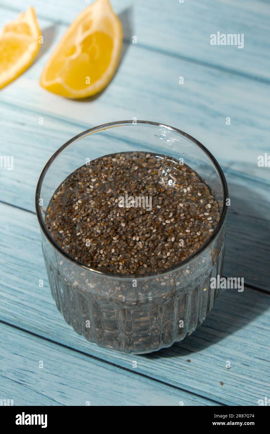 Preparing superfood water drink rich in Omega 3 fatty acids. Pouring ...