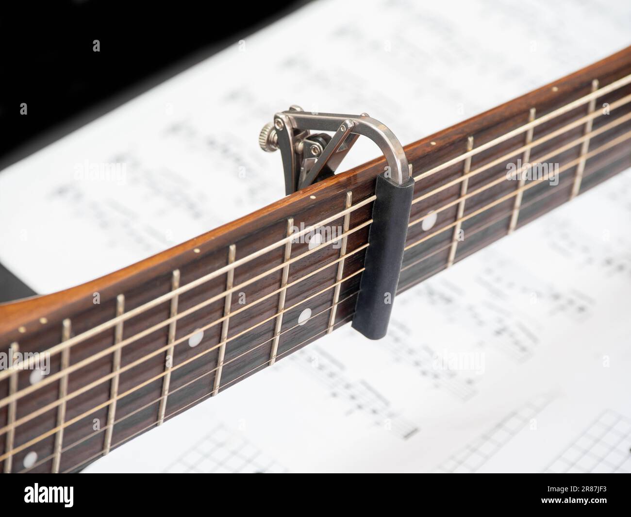 Capo on the Acoustic guitar neck , capro made from aluminium, Selective ...