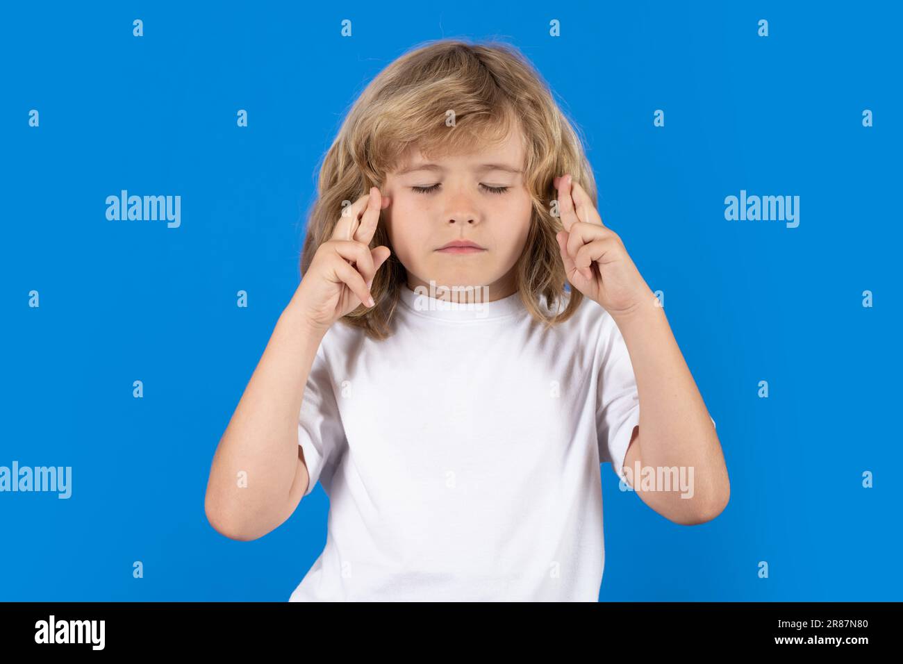 Cute child crossed fingers, isolated studio background. Child closed ...