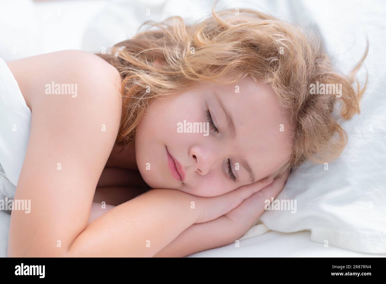 Kid enjoying sweet dreams. Little kid sleeps on bed, napping. Cute ...