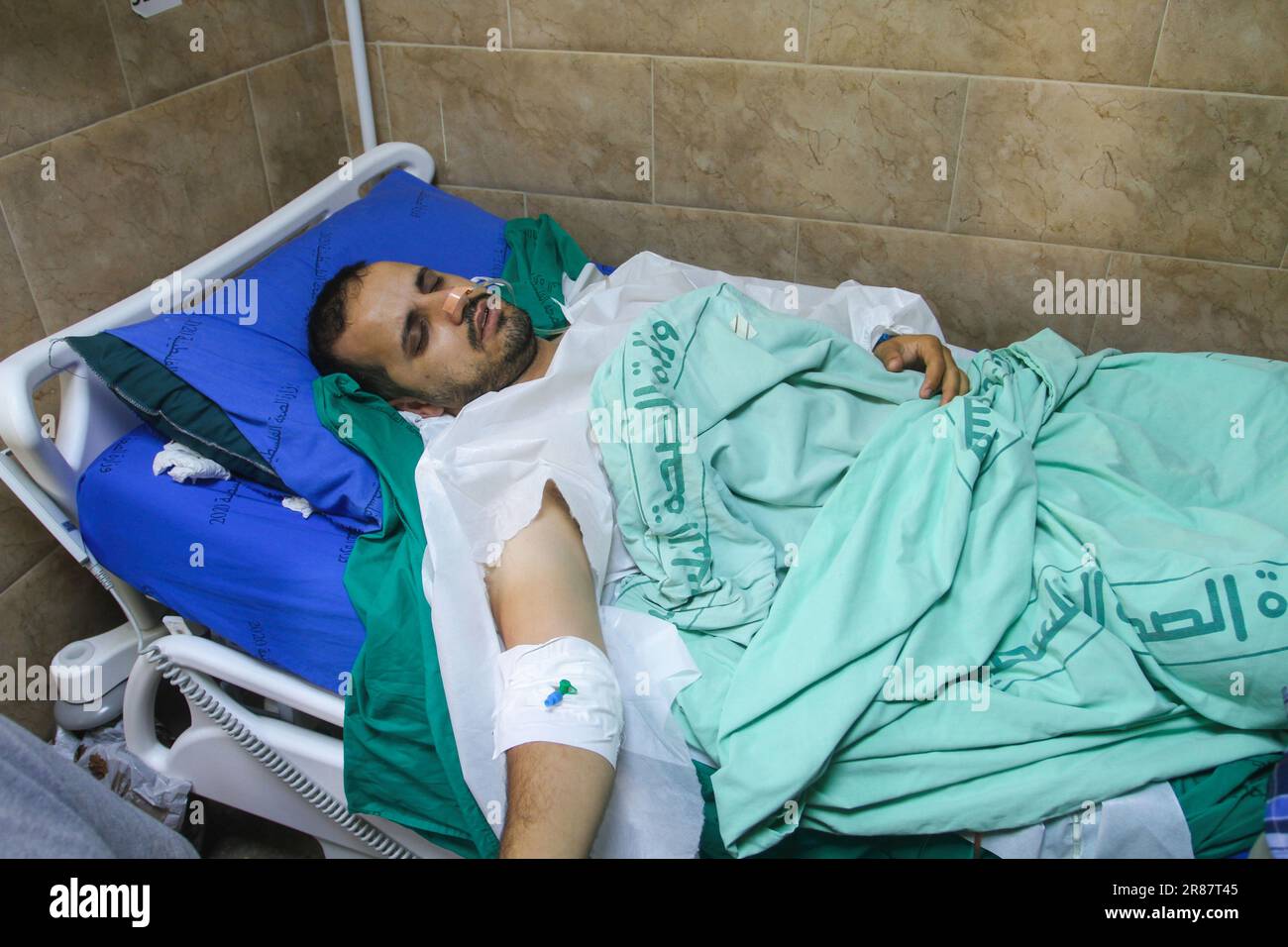 An injured Palestinian journalist seen laying on the hospital bed after ...