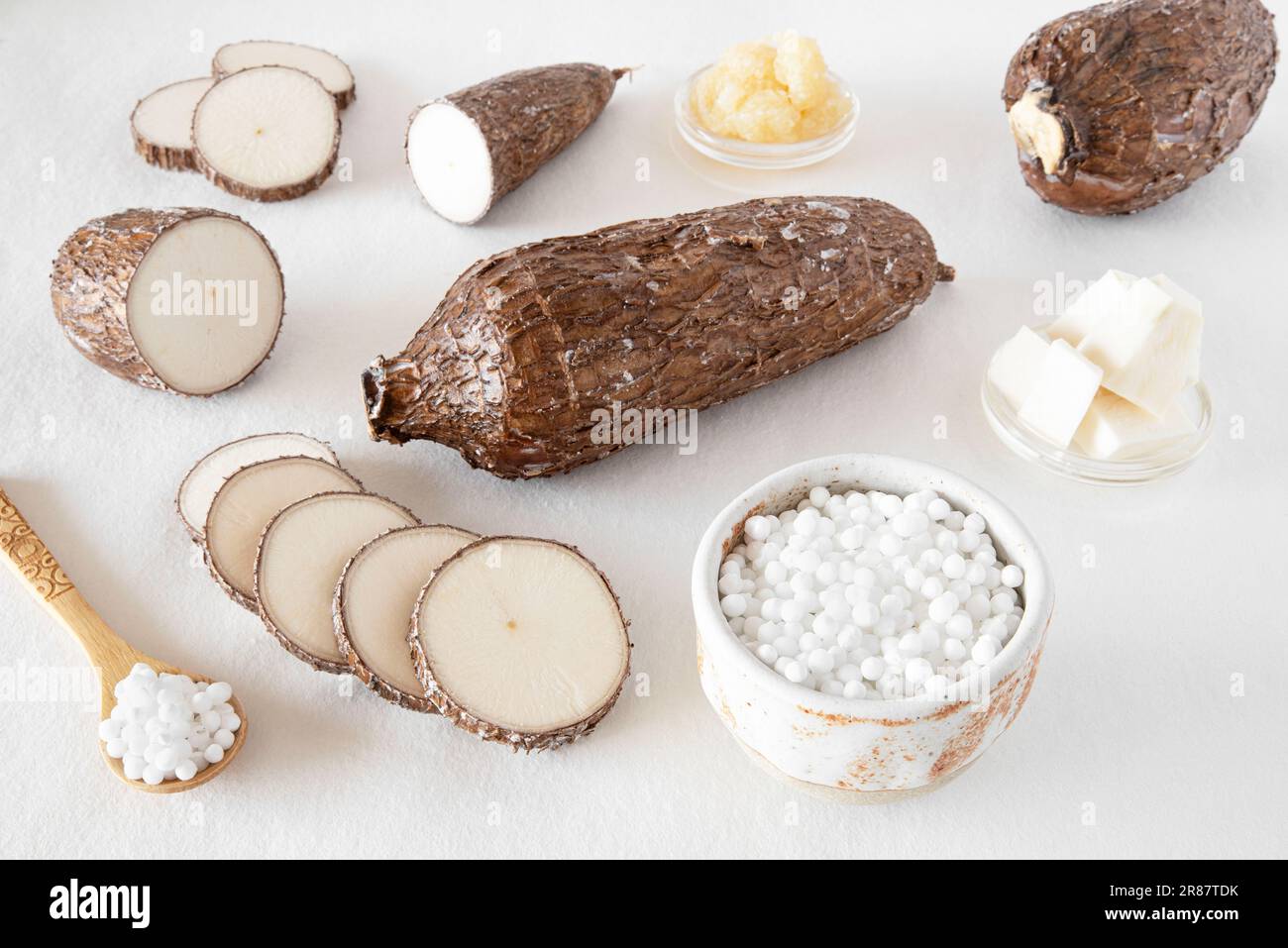 Close-up of a cassava root on a white background with tapioca pearls ...