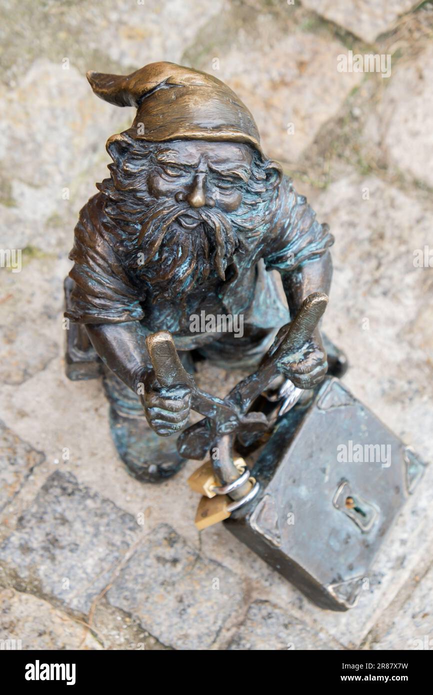 Dwarf with a padlock near bridge. Small bronze figures of gnomes on the ...