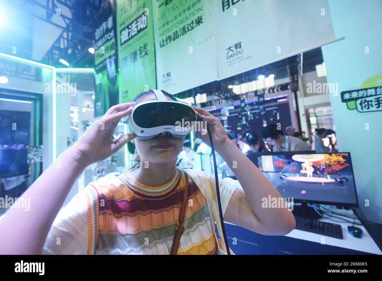 A viewer watches an animation film through VR at the 2023 China ...