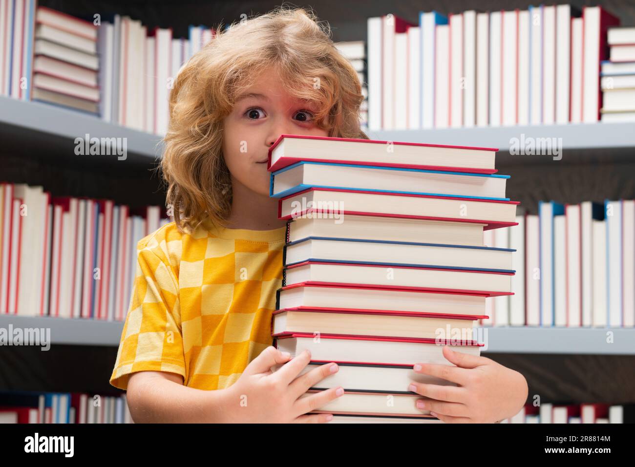 Funny school kid hold stack of books. Elementary schoolboy. School kid ...