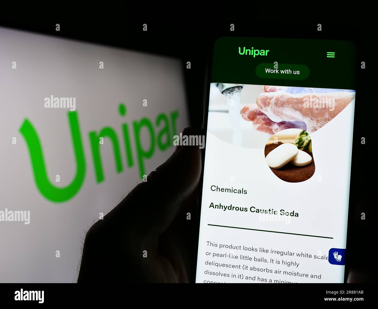 Person holding smartphone with webpage of Brazilian company Unipar ...