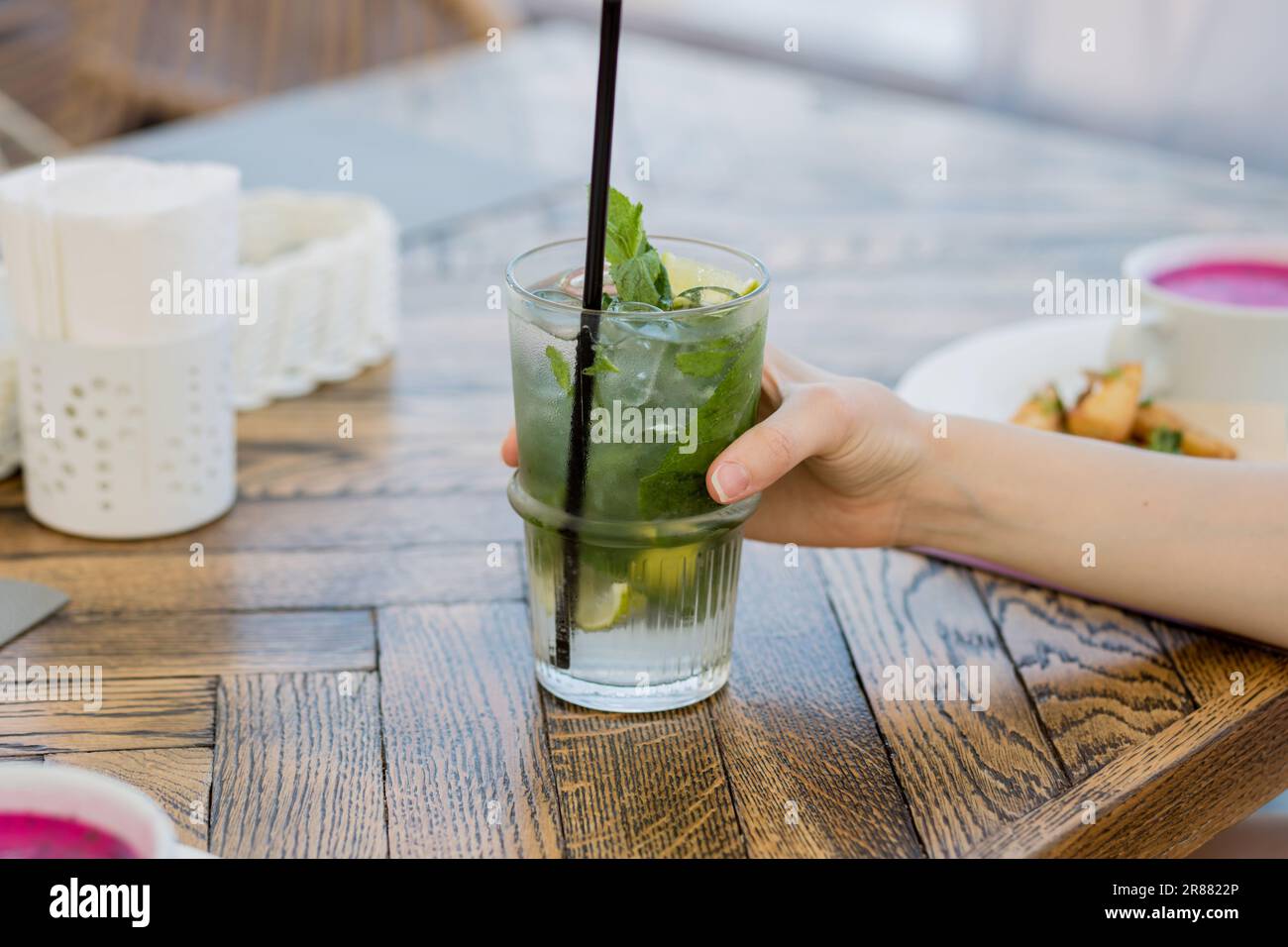 Hand holding refreshing mojito hi-res stock photography and images - Alamy
