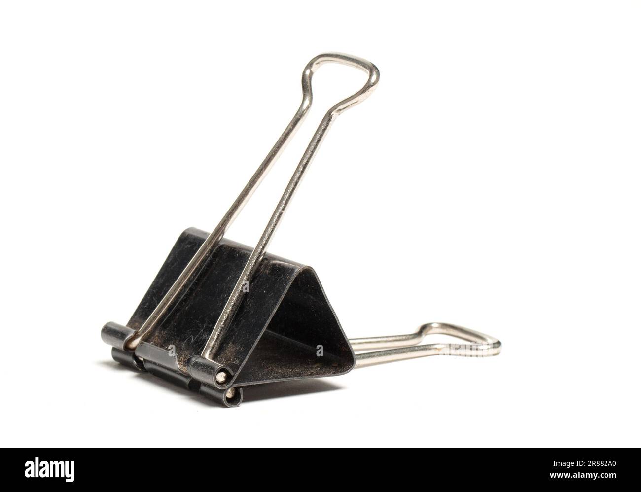 Old black metal clip, isolated on white background Stock Photo - Alamy