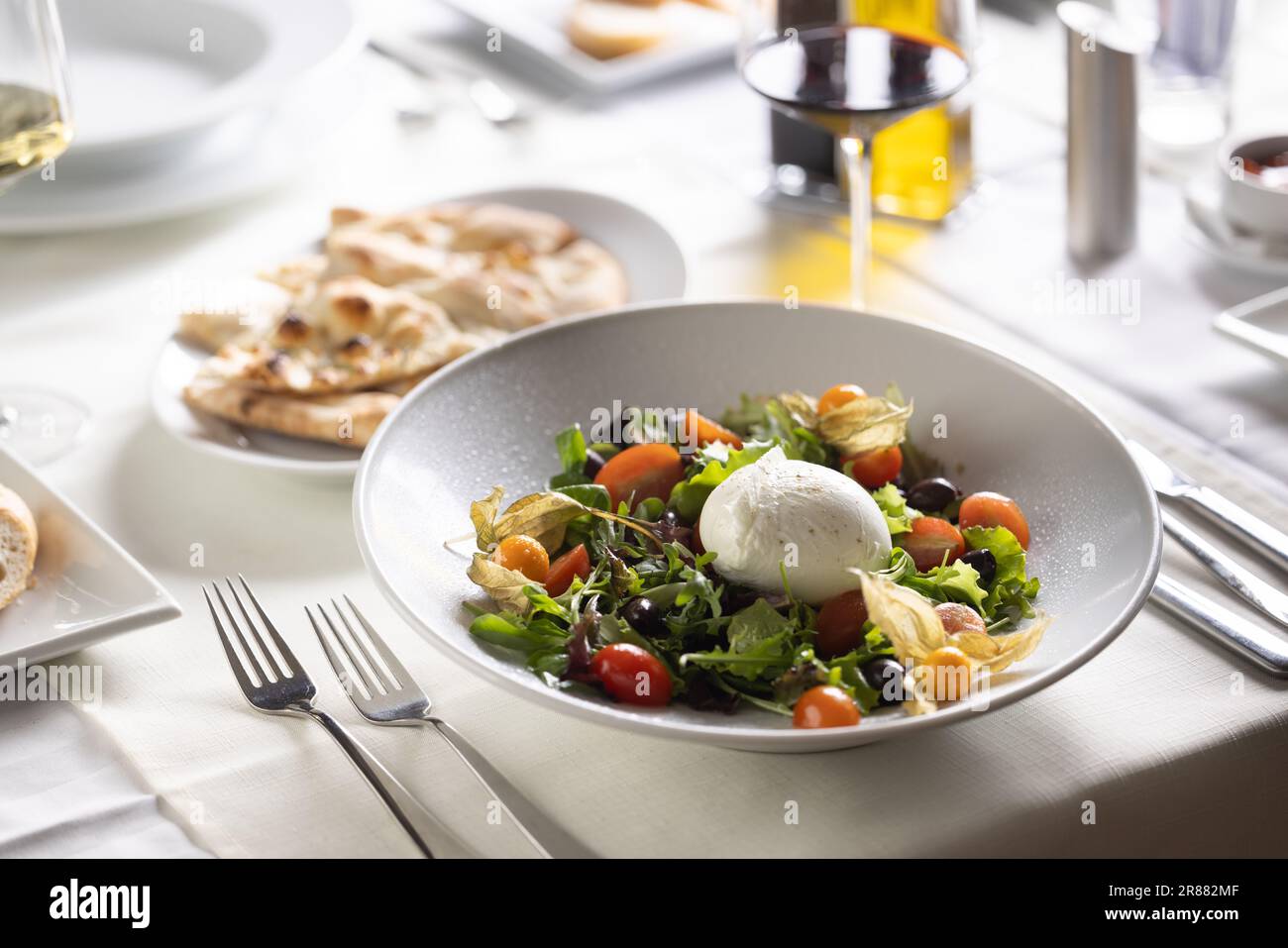 Italian salad with ball of Buffalo mozzarella in the middle served in a ...