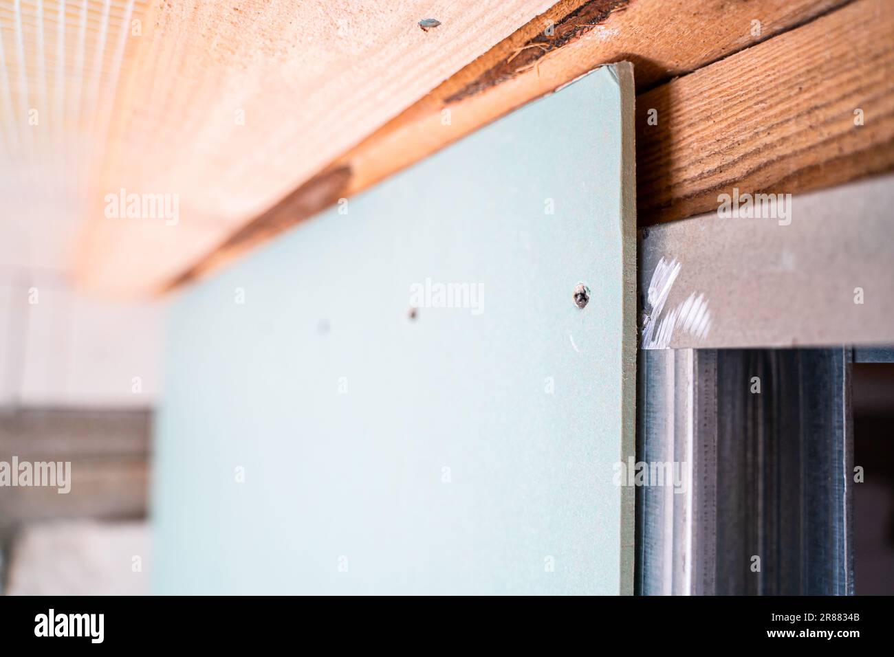 The beginning of the process of sheathing the frame with drywall. One ...