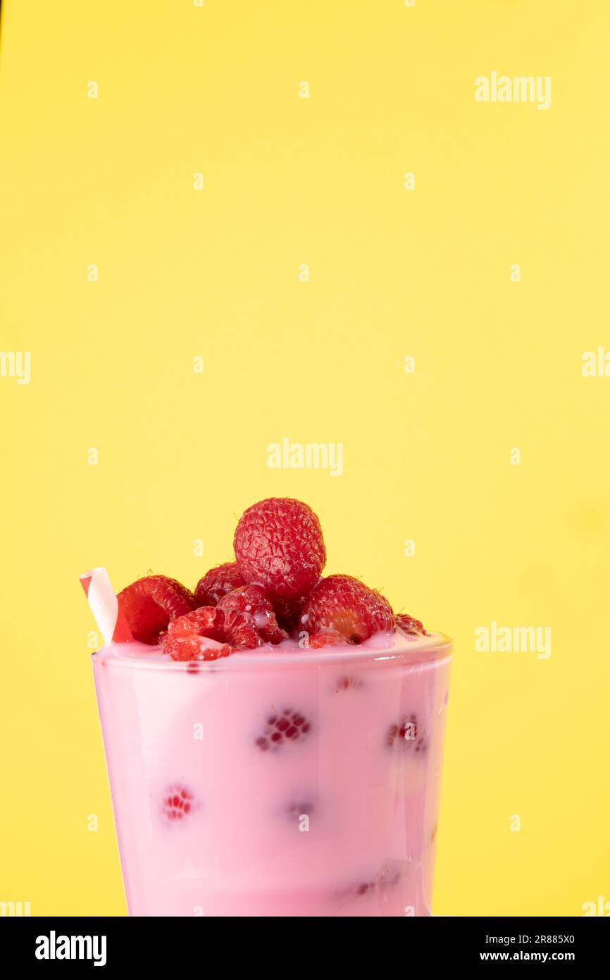 pink berry smoothie on yellow background vertical copyspace Stock Photo ...