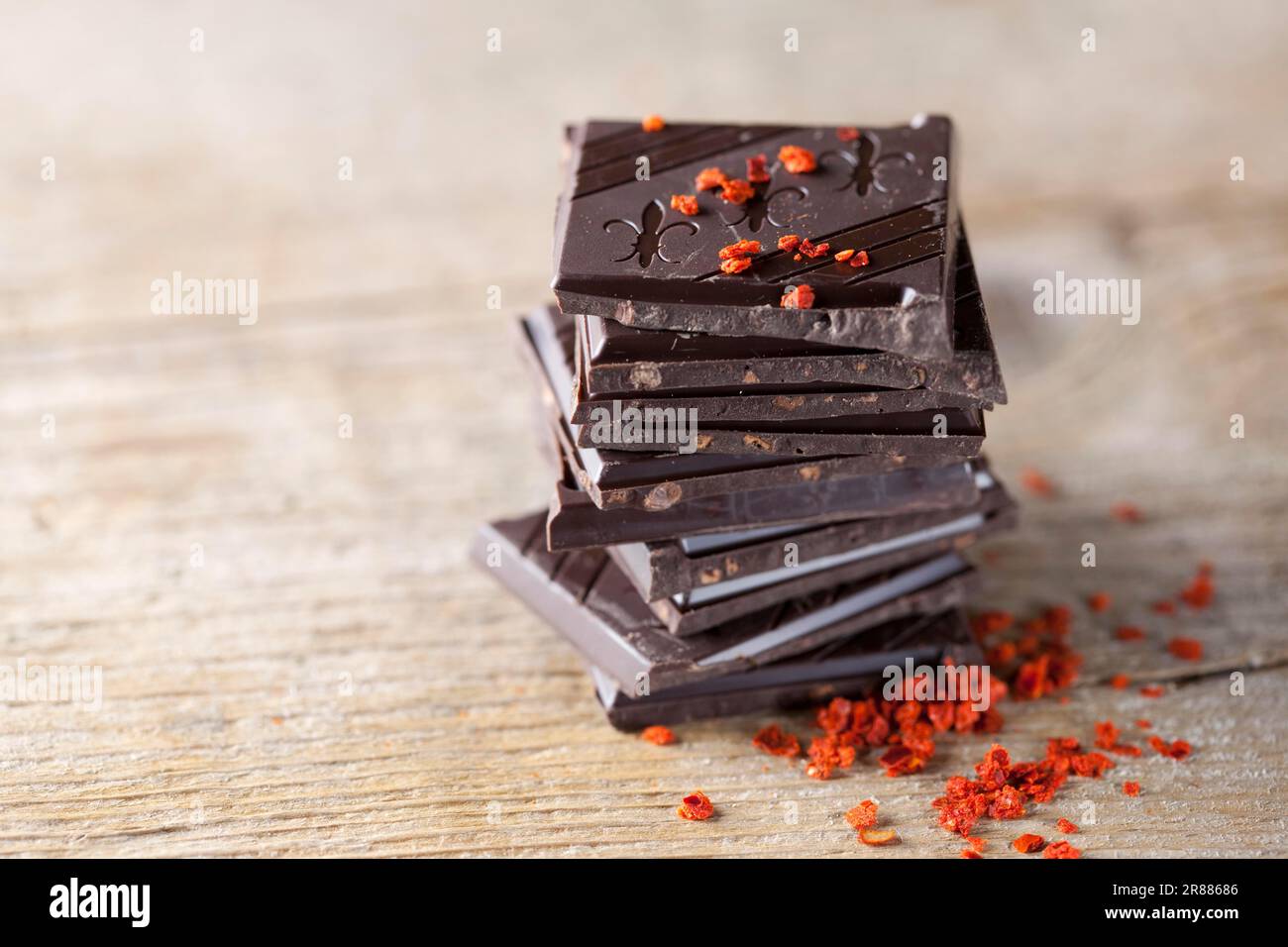 Decorative chocolate stack on wooden board with chilli flakes Stock ...