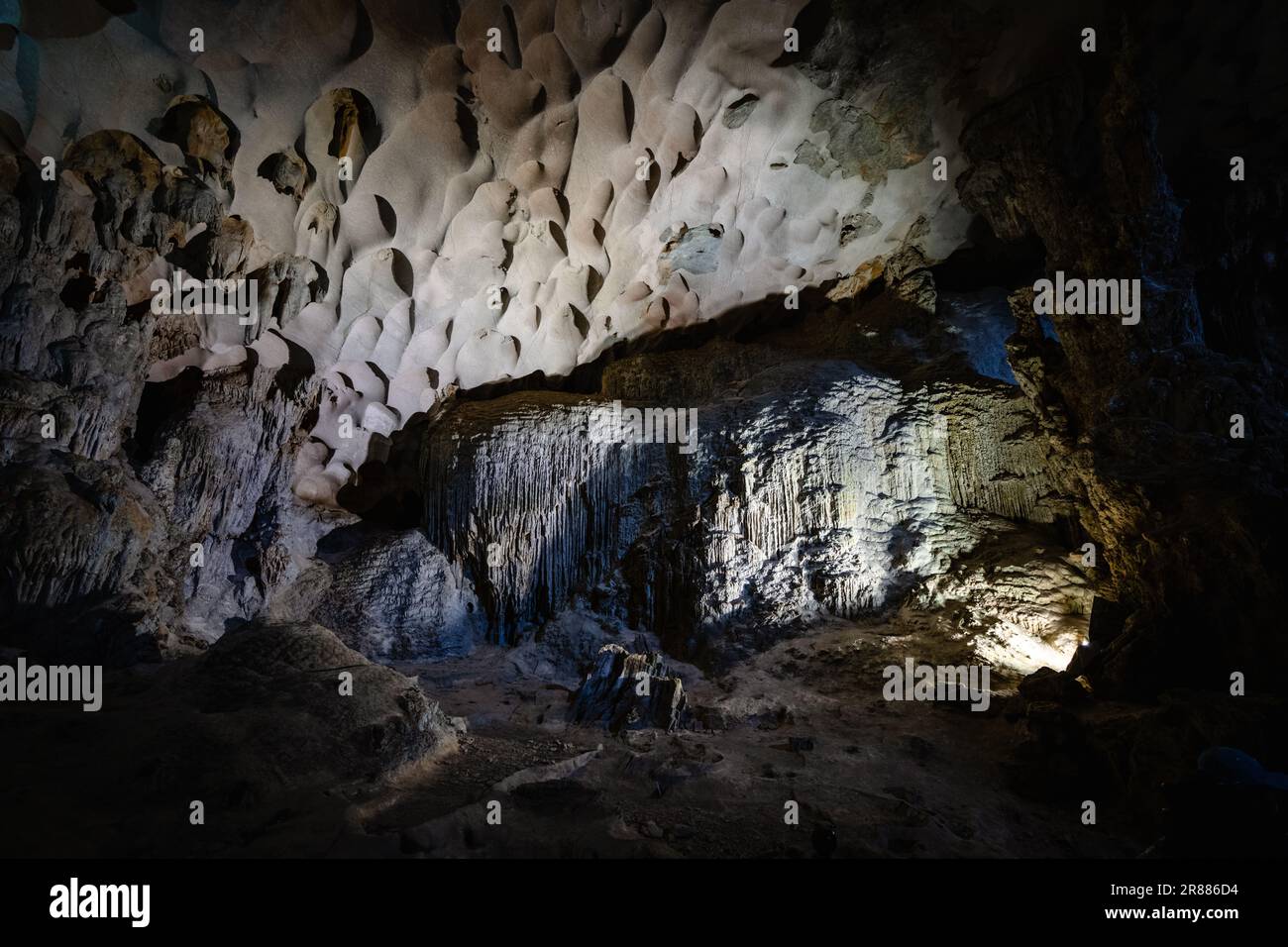 A bright light radiates through the opening of an underground cave ...