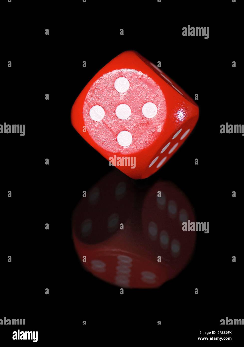 Red dice with reflection on black Stock Photo - Alamy