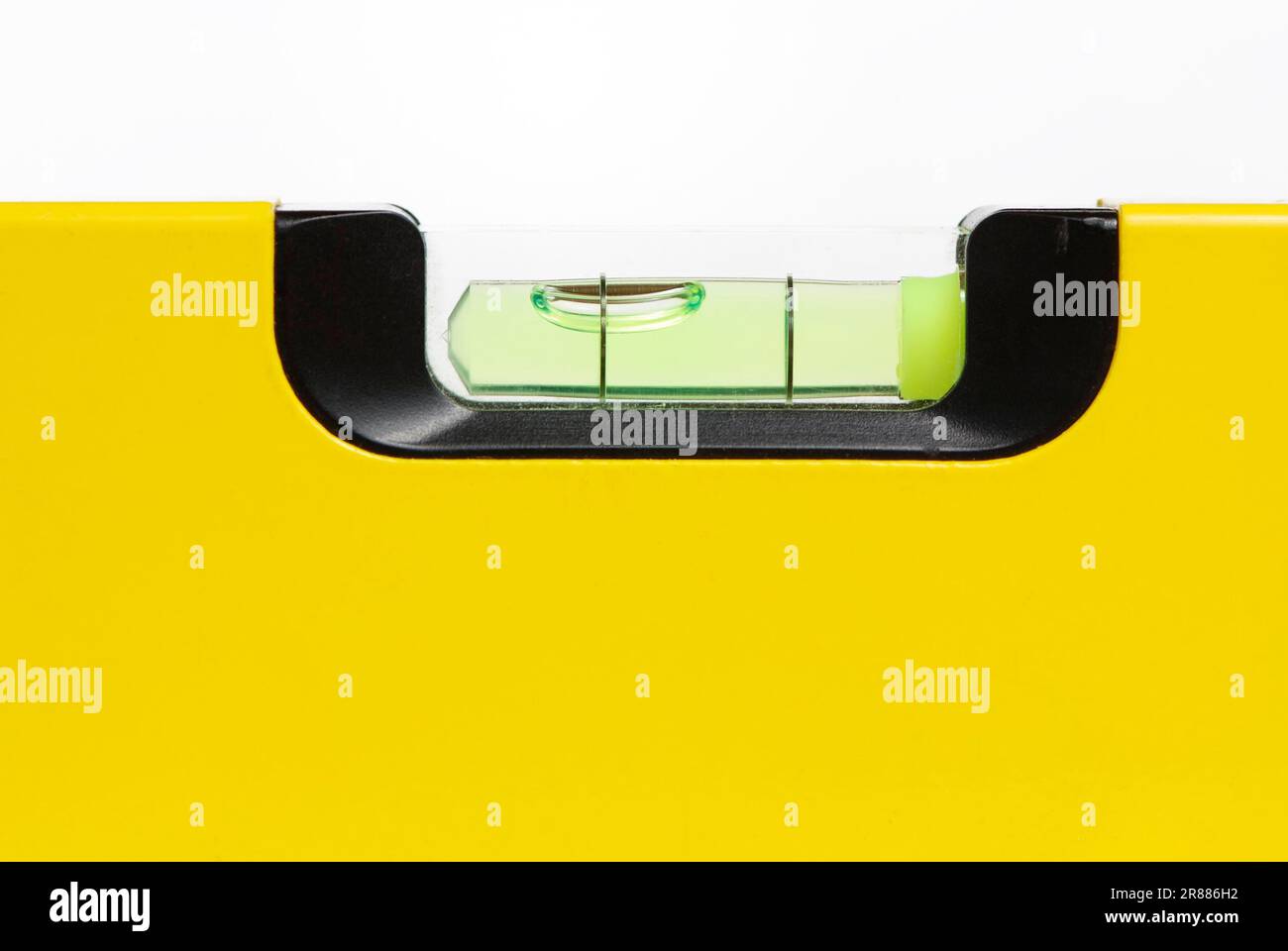 Yellow bubble level out of balance Stock Photo - Alamy