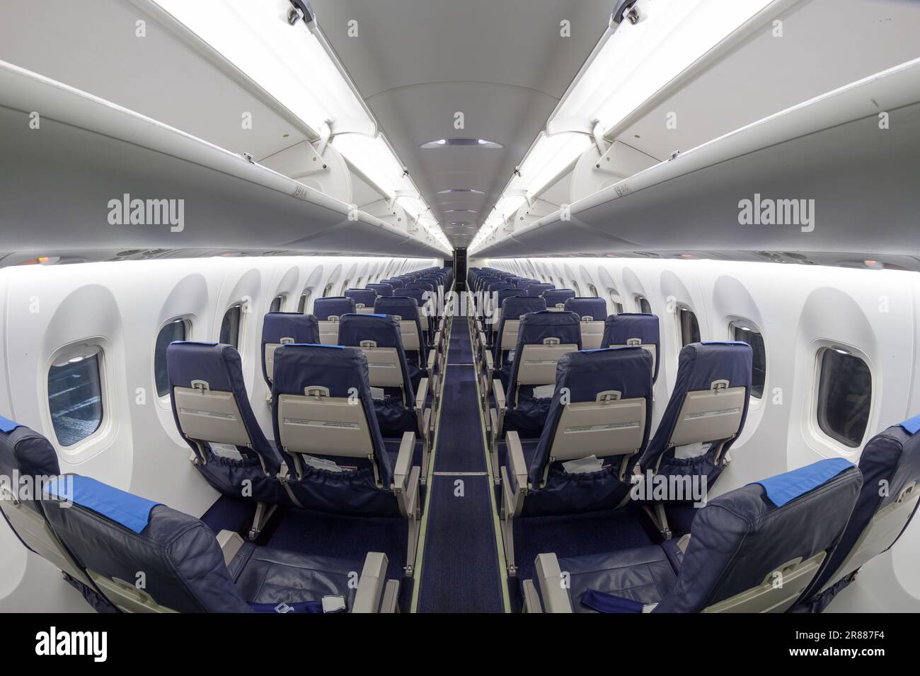 An interior of an airplane with two rows of seats Stock Photo - Alamy
