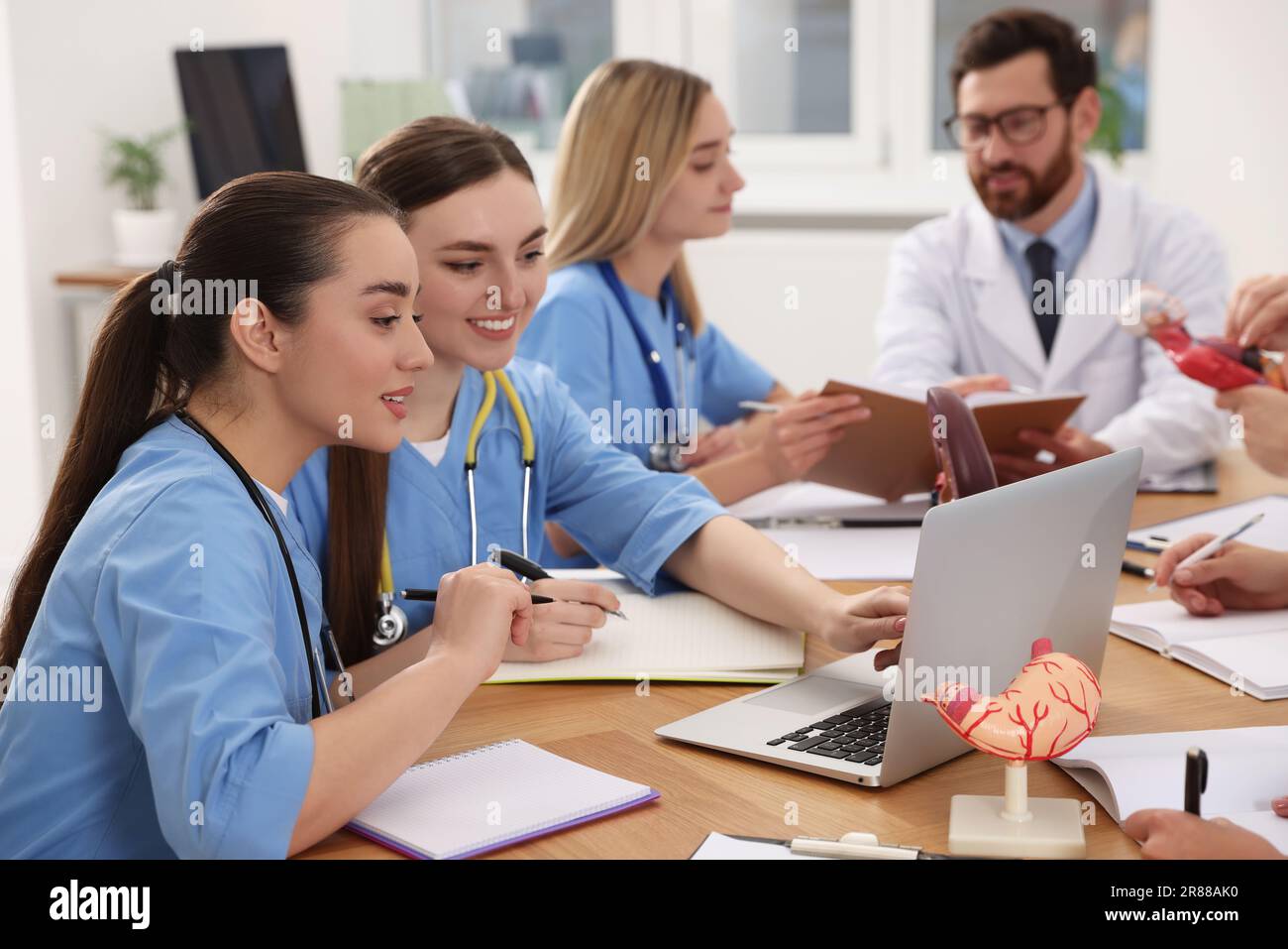 Medical students in uniforms studying at university Stock Photo - Alamy
