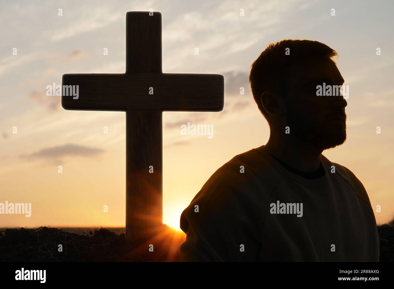 Atheism. Silhouette of man turned away from Christian cross outdoors at ...