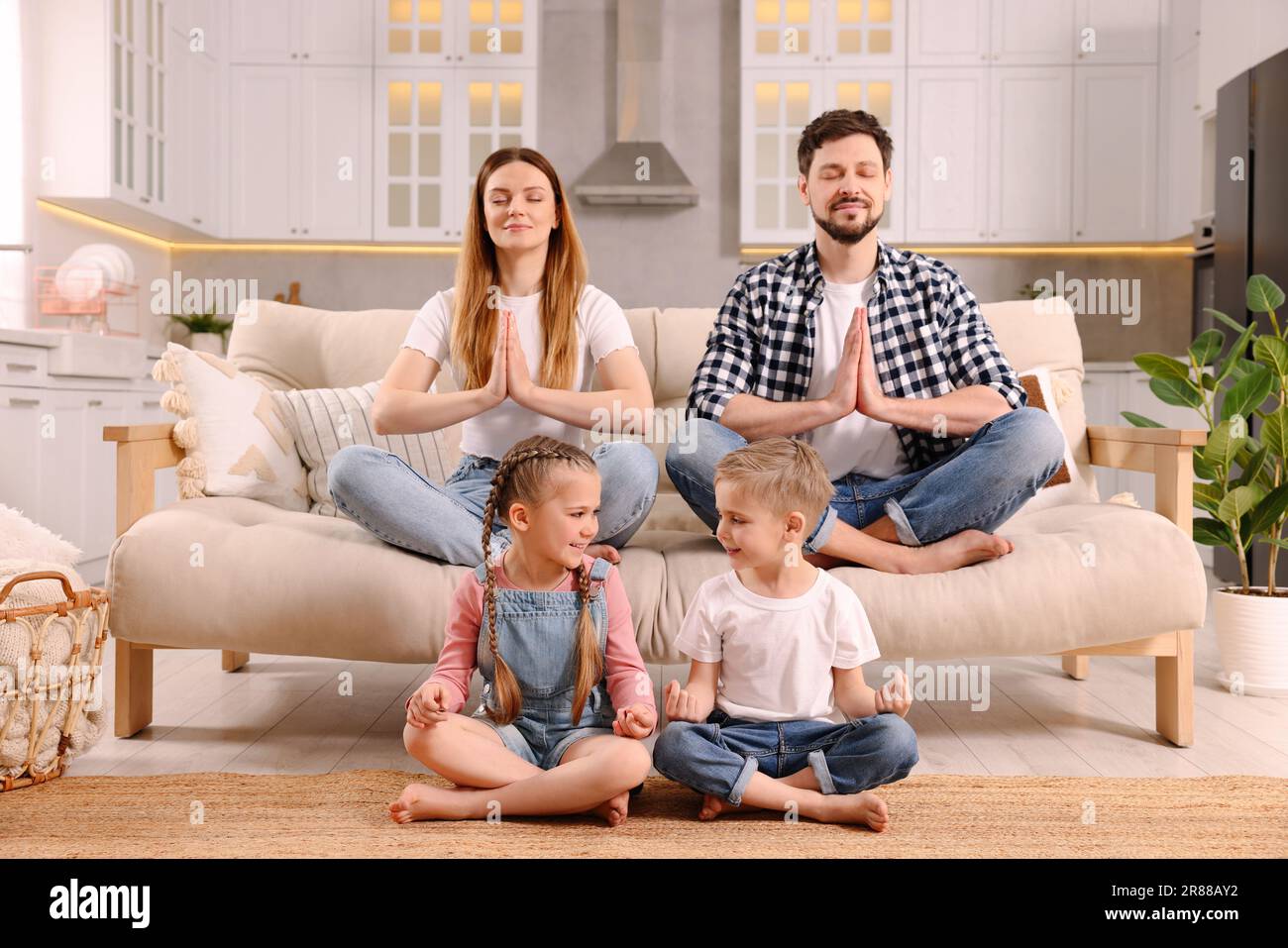 Family meditating together at home. Harmony and zen Stock Photo - Alamy