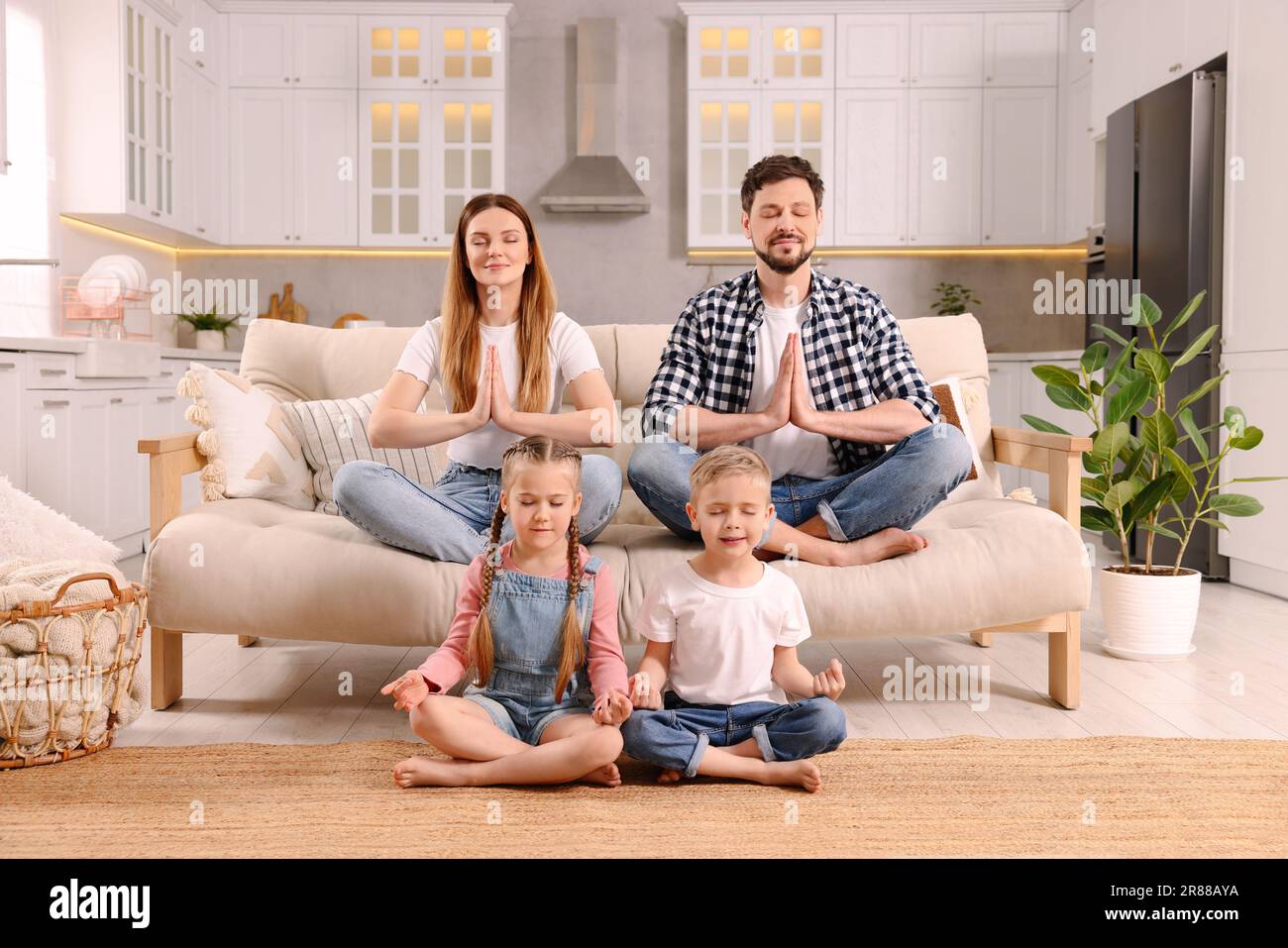 Family meditating together at home. Harmony and zen Stock Photo - Alamy
