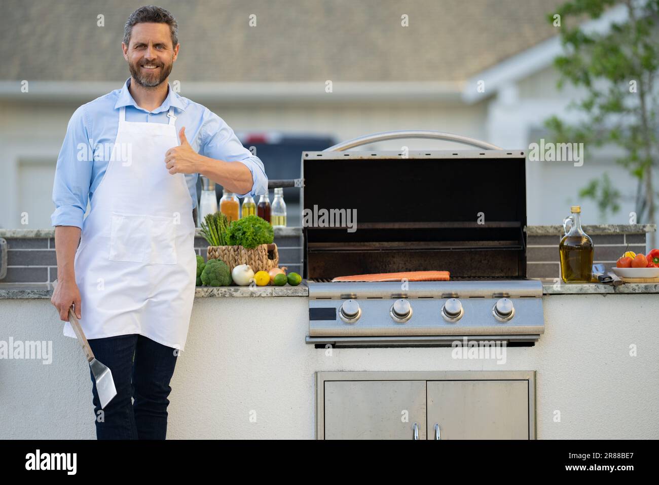 man grilling salmon fillet for barbecue, thumb up. man grilling salmon ...
