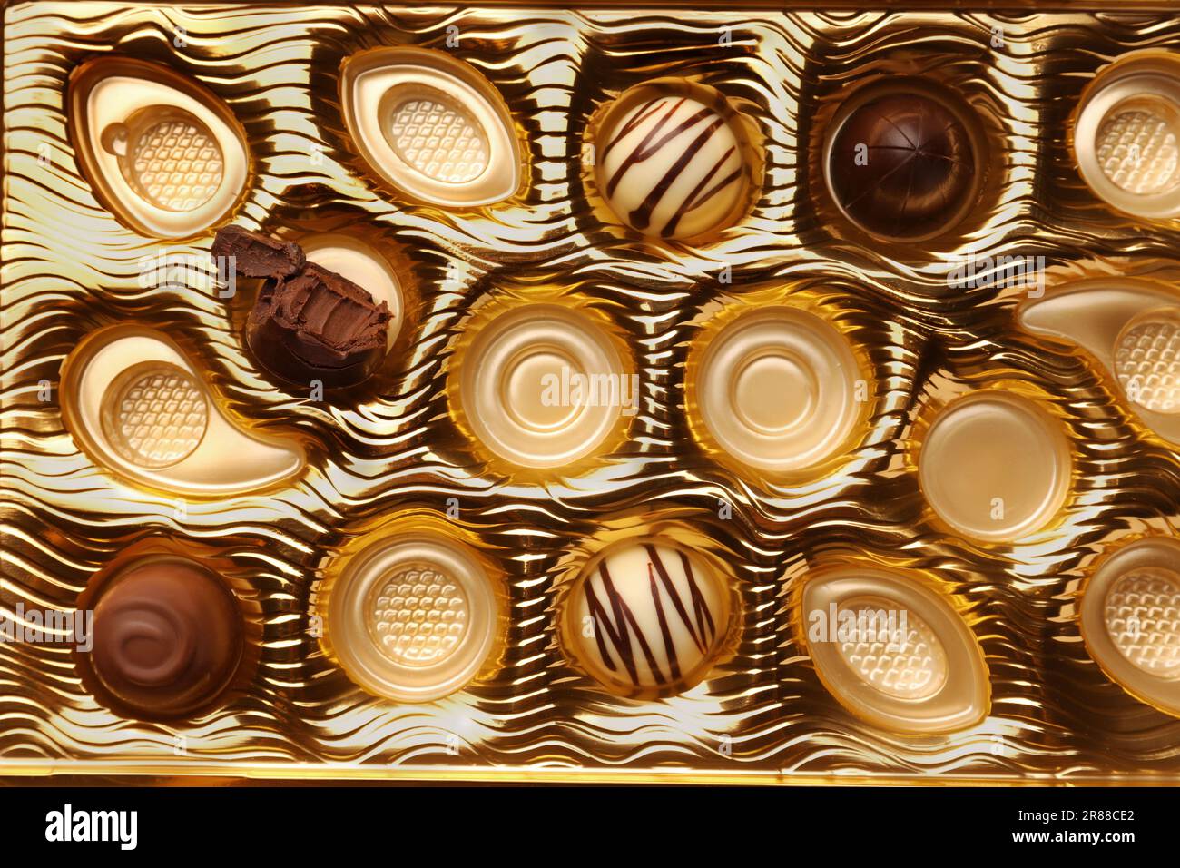 Partially empty box of chocolate candies as background, top view Stock ...