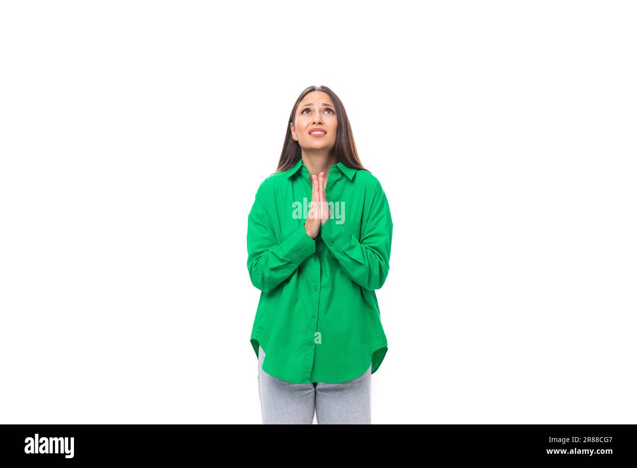 praying slim european brunette woman with long hair and brown eyes ...