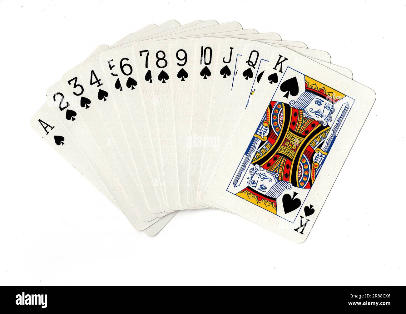 A fan of vintage playing cards featuring spades on a white background ...