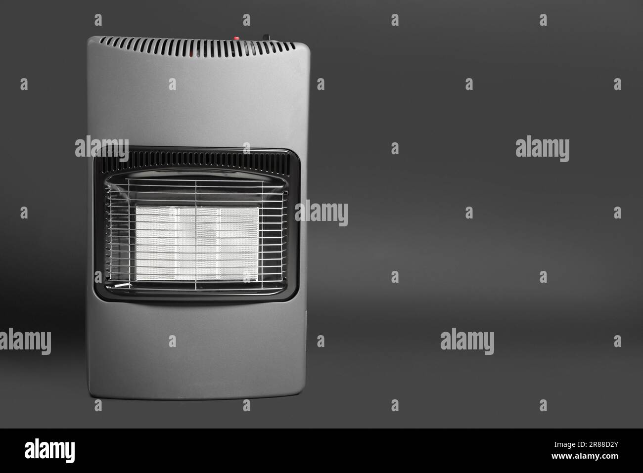 Modern gas heater on dark grey background, space for text. Military ...